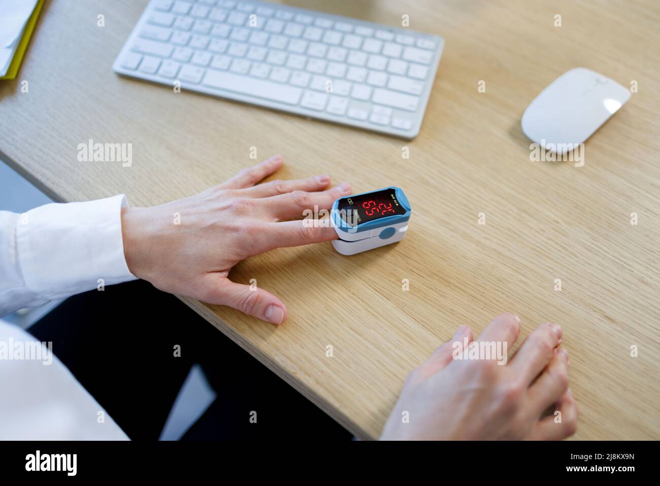 Closeup view of a business woman measuring blood oxygen levels using a ...