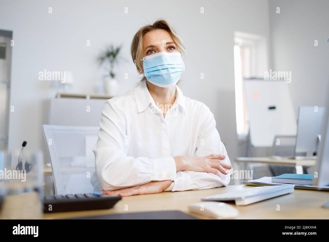Portrait of a adult business woman in formal wear and medical mask in ...