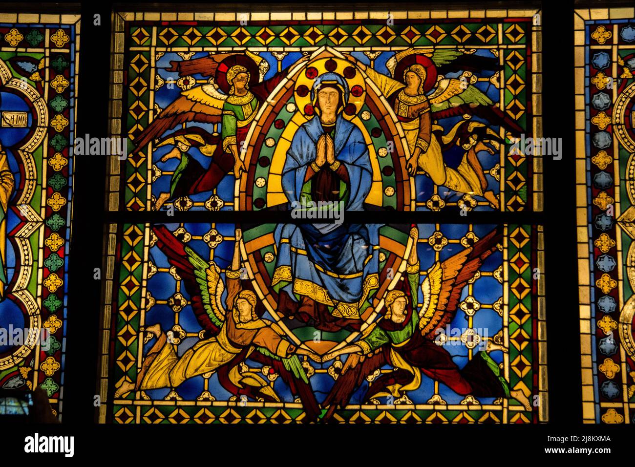 Light through stained glass rosettes, representing religious images ...