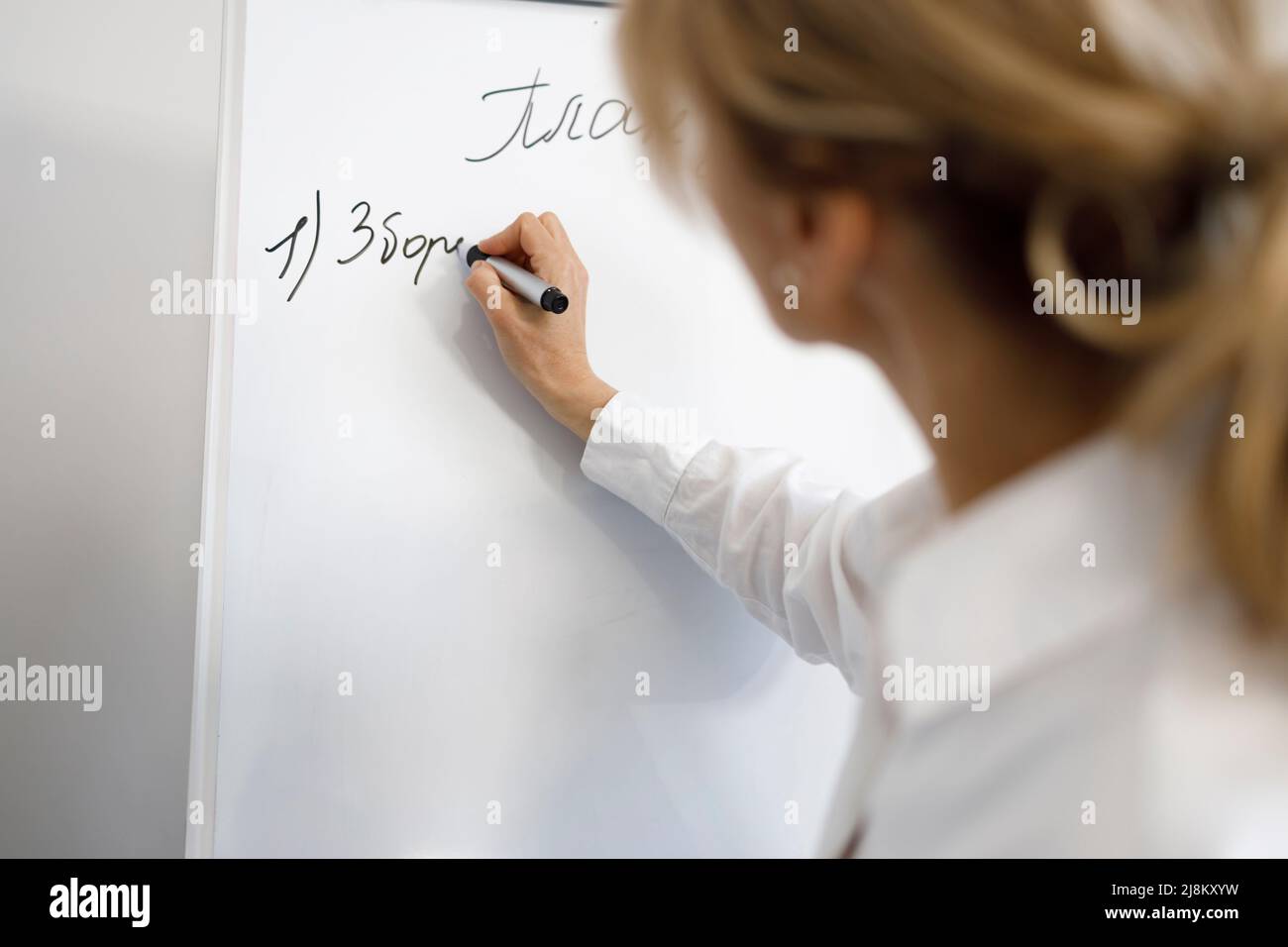 Business woman or teacher writing on a white magnetic flipchart Stock ...