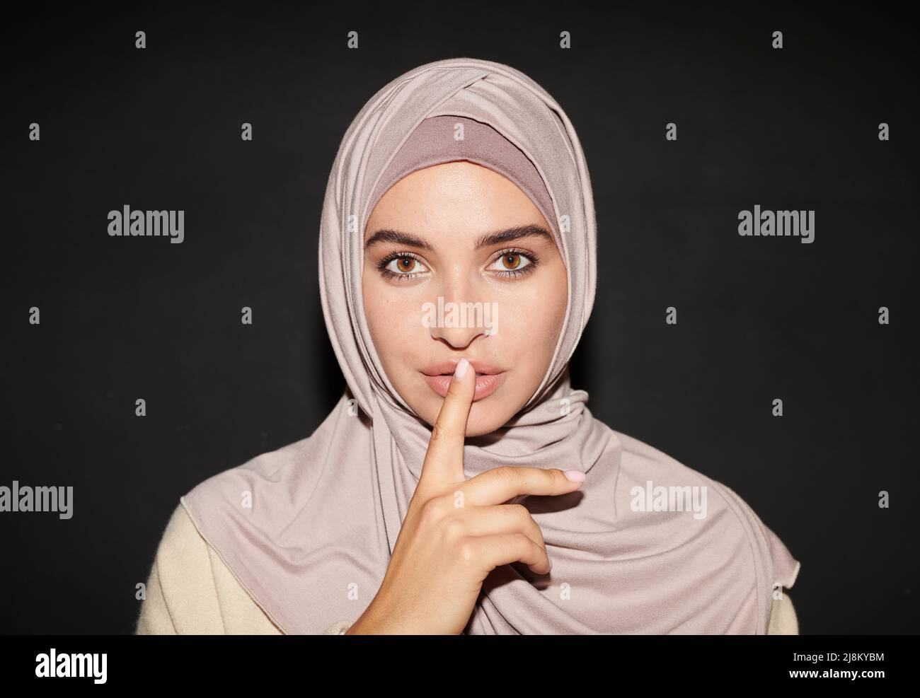 Horizontal head and shoulders shot of modern Muslim woman wearing hijab ...