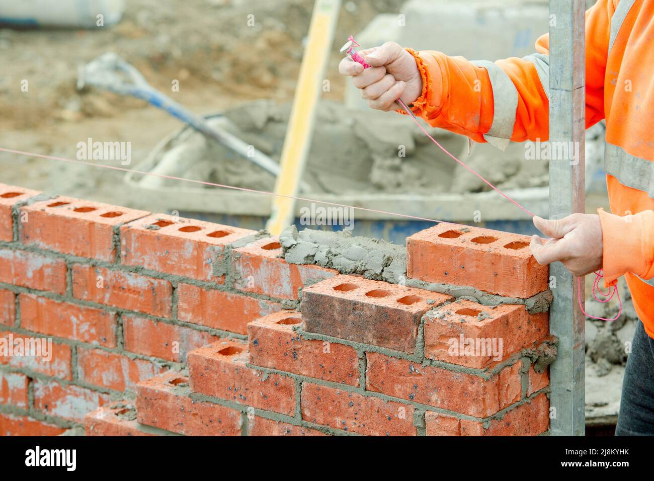 Bricklayer laying bricks on mortar on new residential house ...