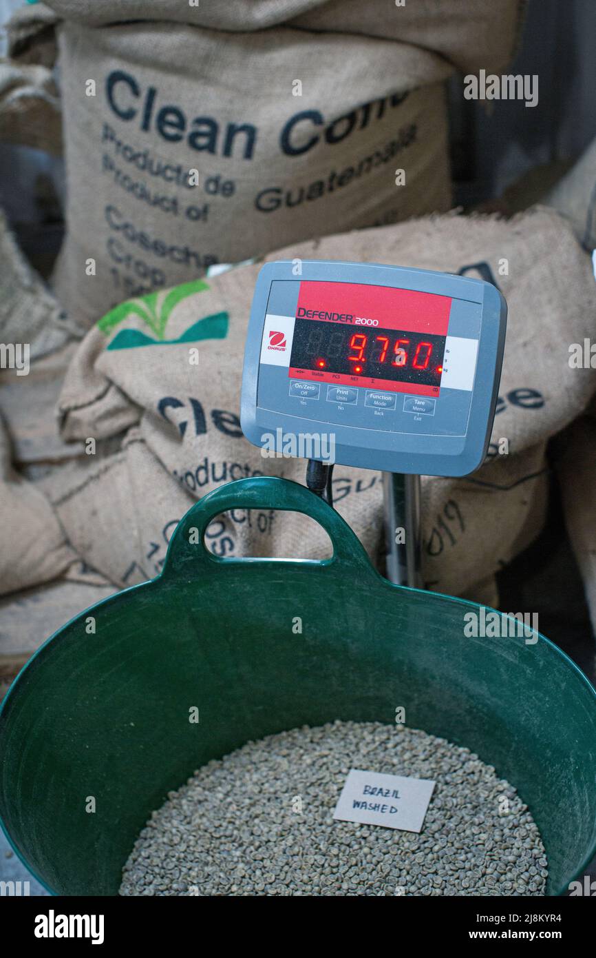 Electronic scales with numbers on screen and green coffee beans Stock ...