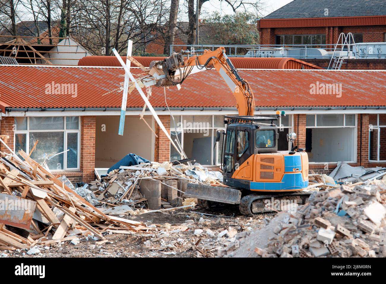 Demolition of an old building with an excavator to give way for a new ...