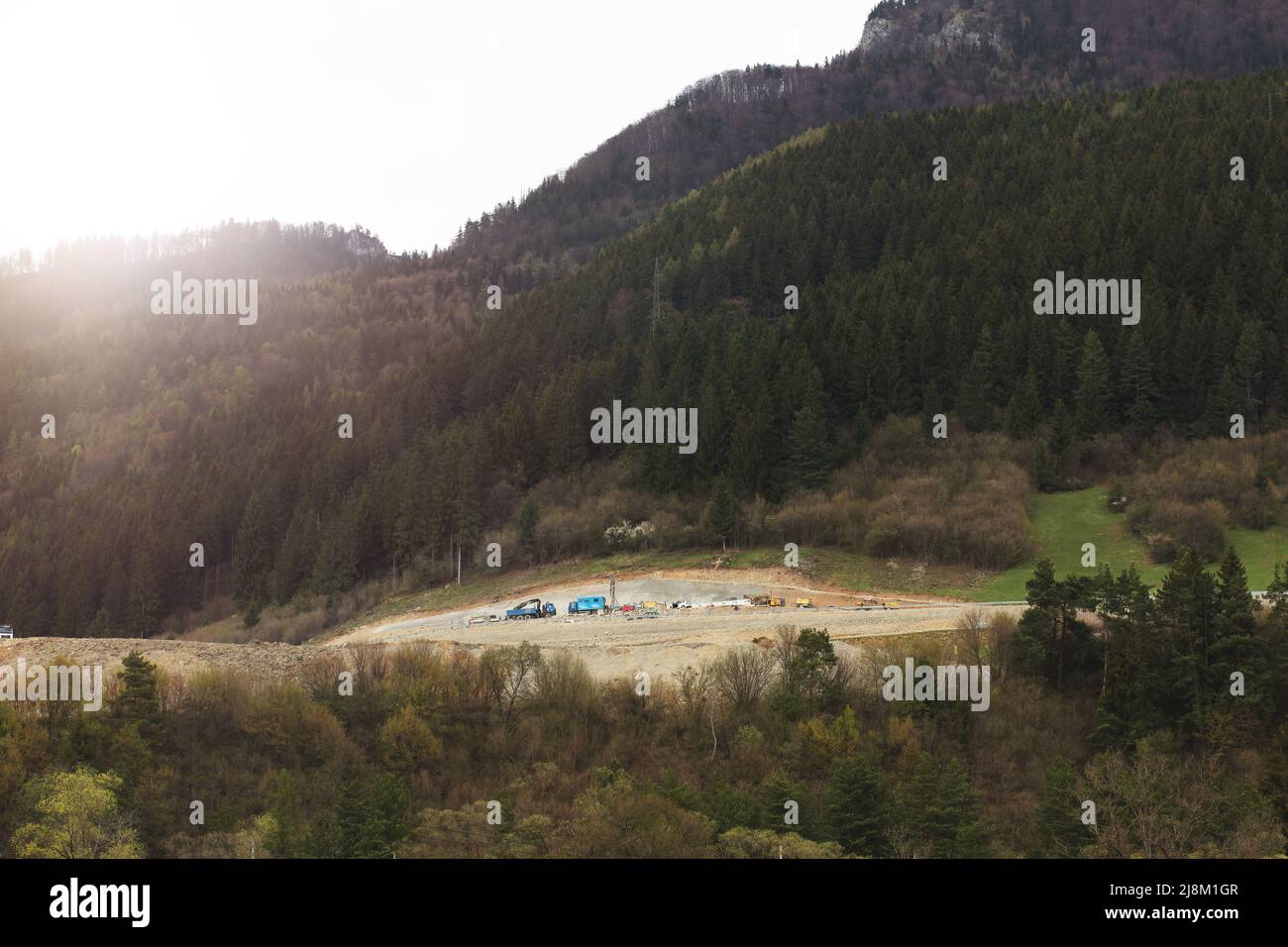 Highway construction works on steep mountain slope. High quality photo ...