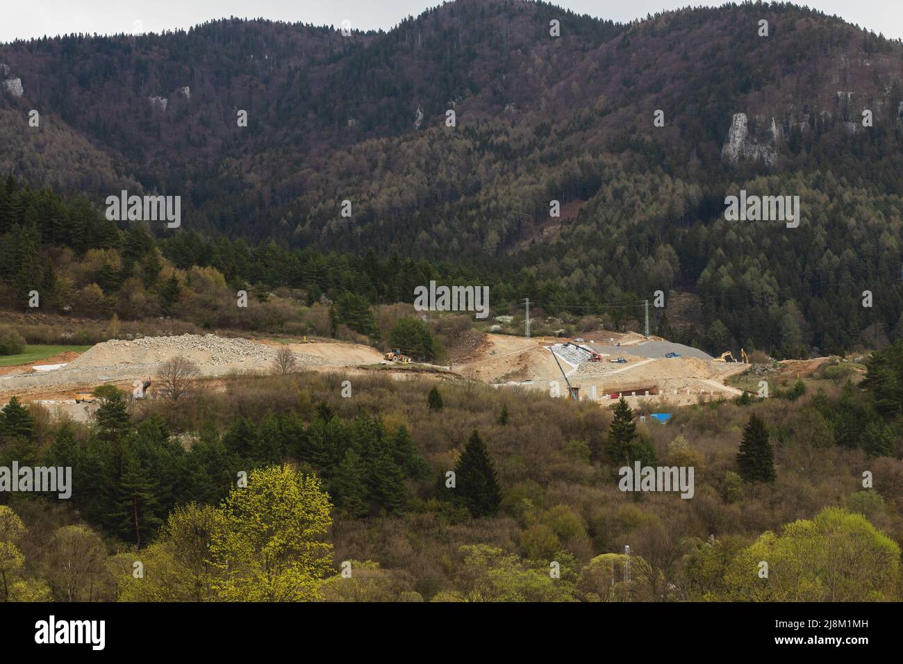Highway construction works on steep mountain slope. High quality photo ...
