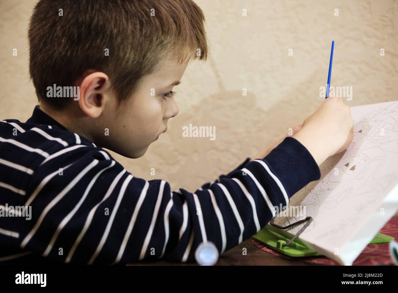 Little boy draws a brush and paint his first picture Stock Photo - Alamy