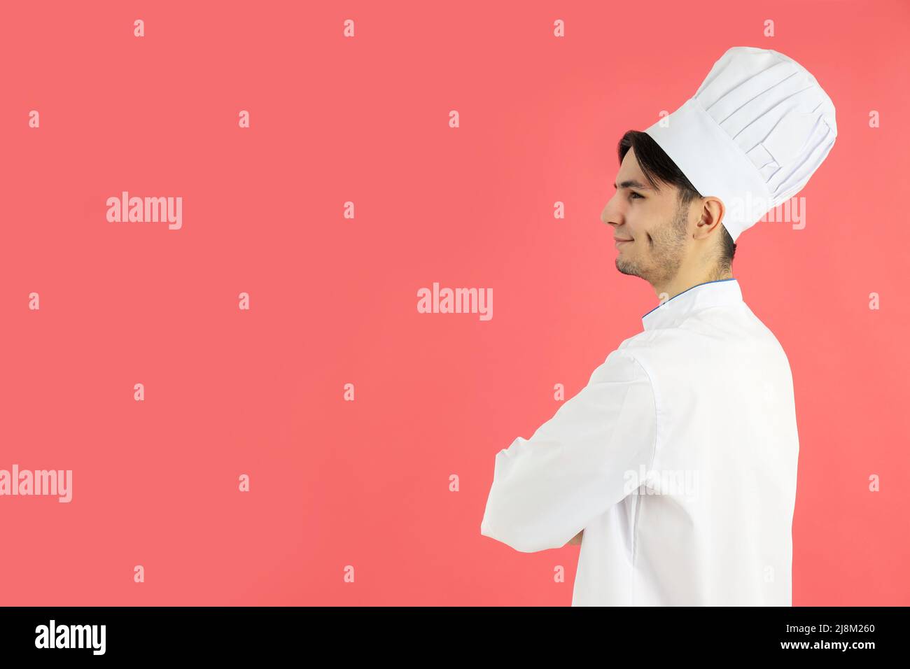 Concept of cooking, young man chef on pink background Stock Photo - Alamy