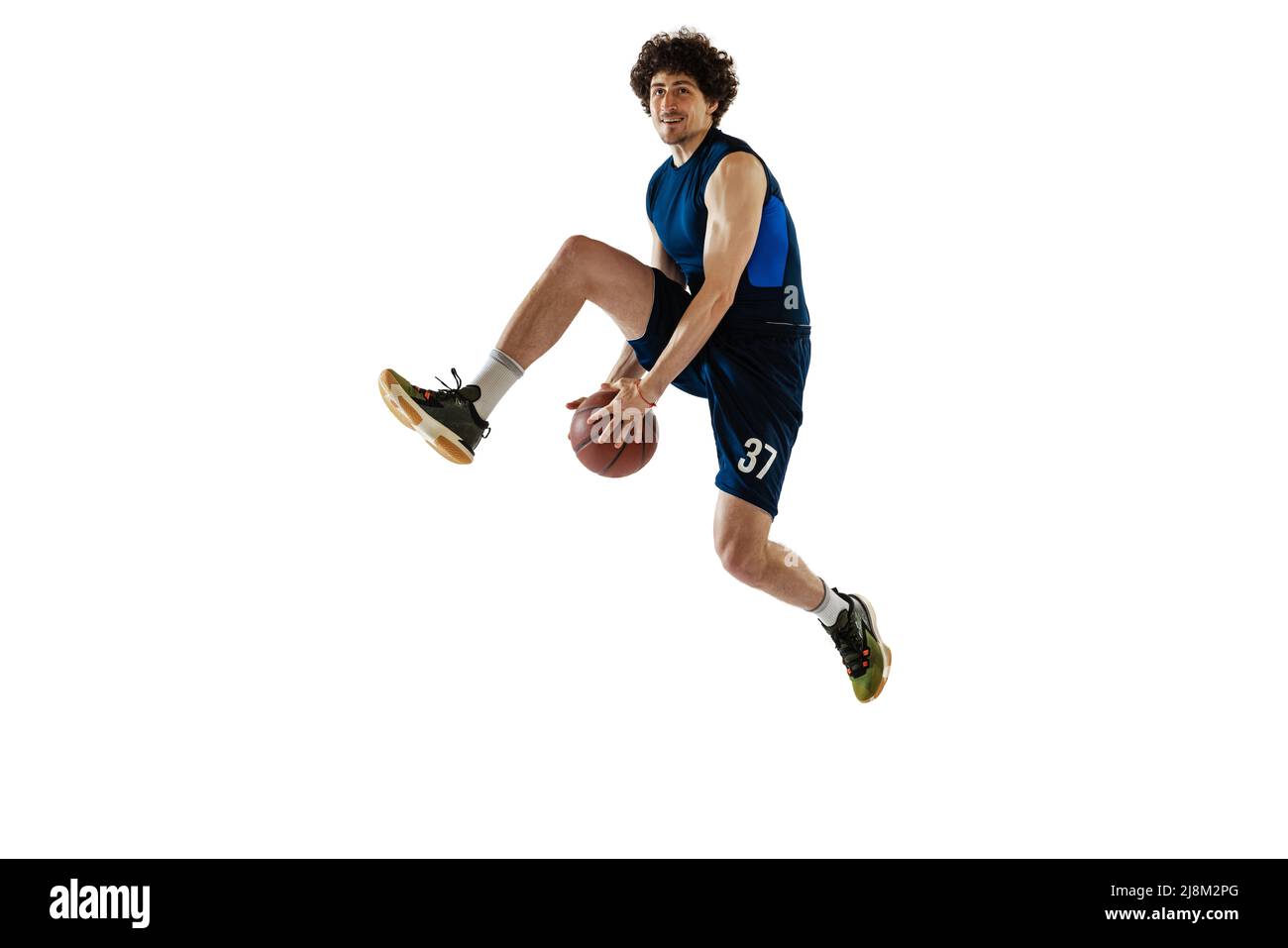 Young muscular basketball player in action, motion isolated on white ...