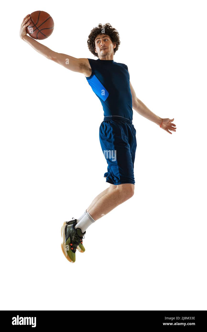 Young muscular basketball player in action, motion isolated on white ...