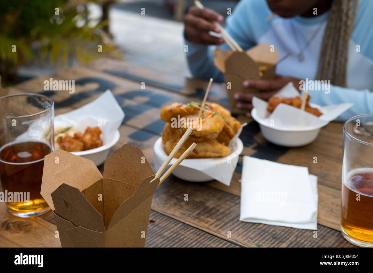 Person using chop sticks to eat food Stock Photo - Alamy