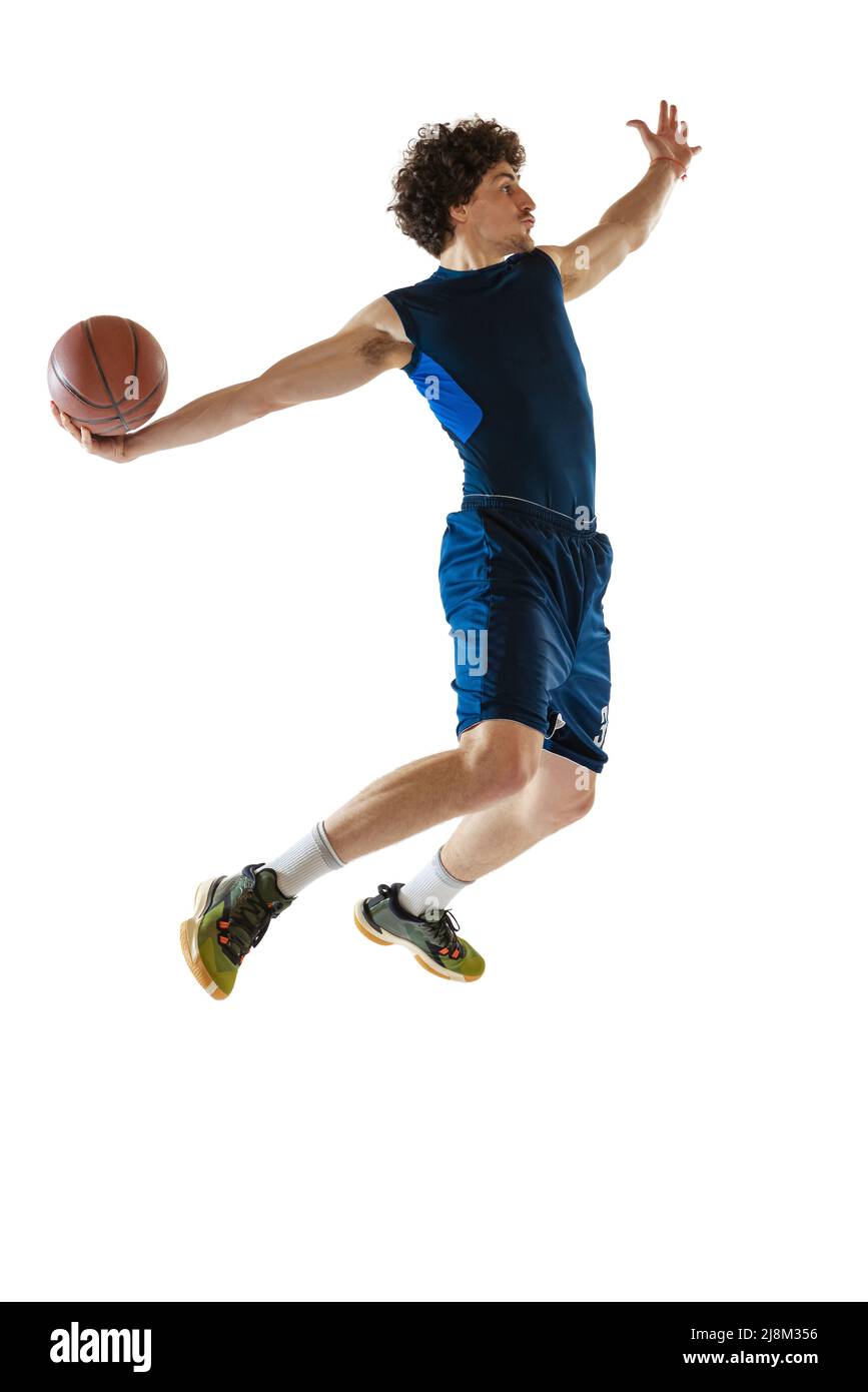 Dynamic portrait of young man, basketball player playing basketball ...