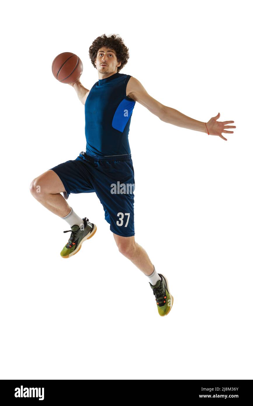 Young muscular basketball player in action, motion isolated on white ...