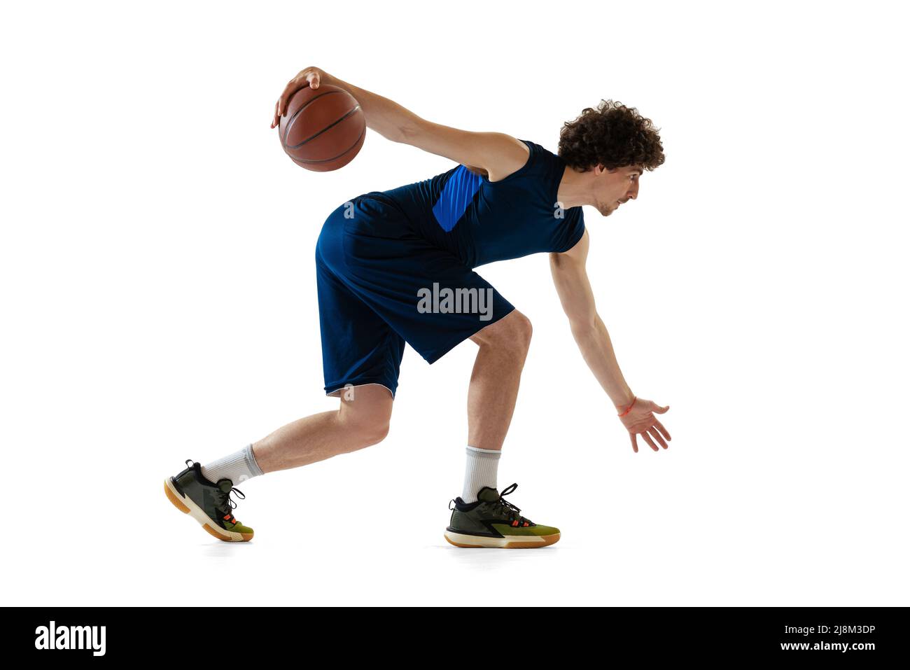Young muscular basketball player in action, motion isolated on white ...