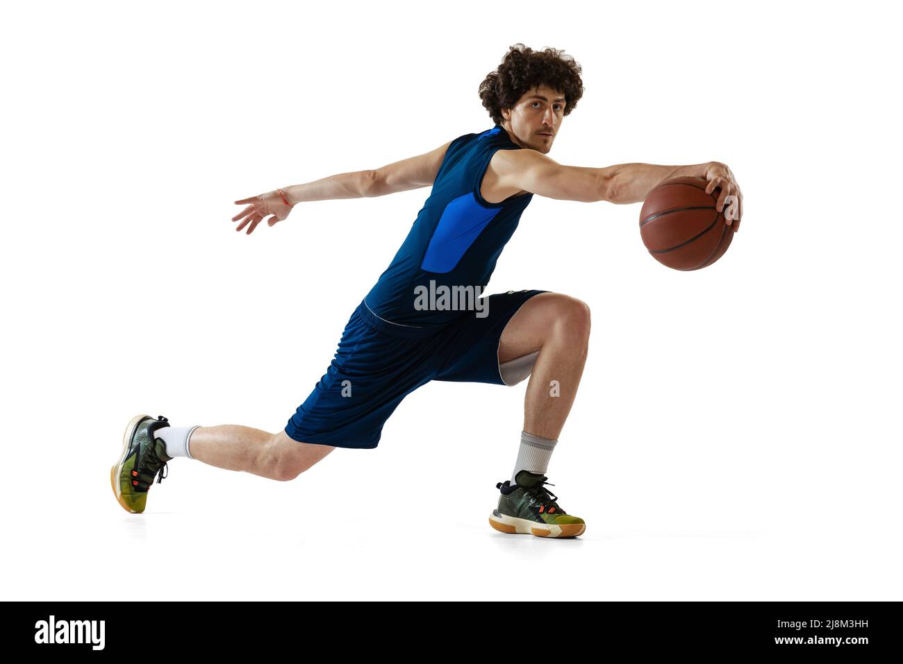 Young muscular basketball player in action, motion isolated on white ...
