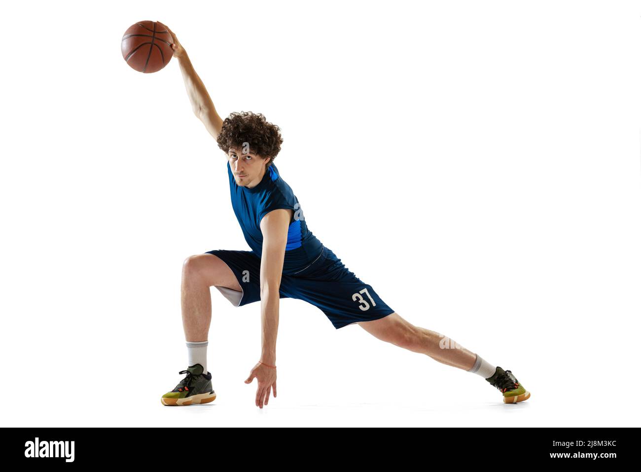 Young muscular basketball player in action, motion isolated on white ...