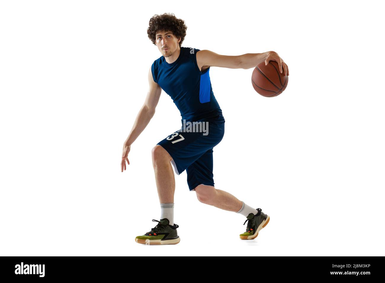 Young muscular basketball player in action, motion isolated on white ...