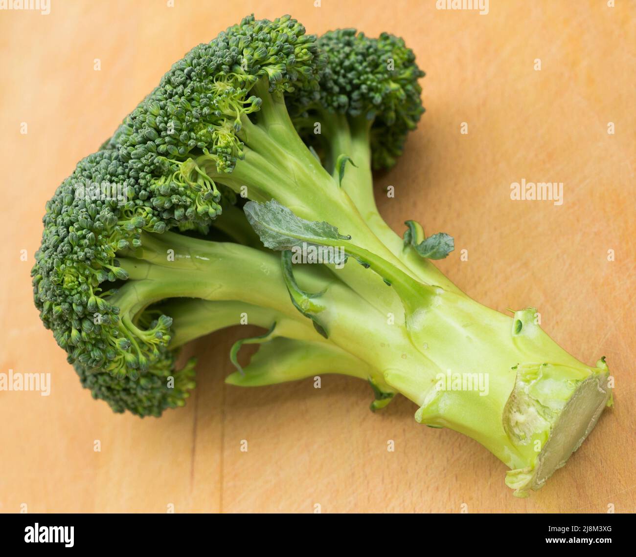 healthy broccoli and florets on wooden board Stock Photo - Alamy