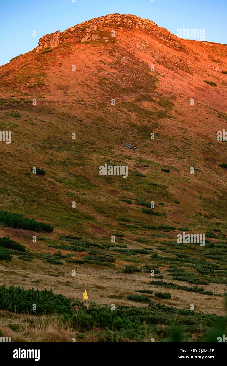 Woman is Mount Turkul, bright clothes in the mountains, autumn ...