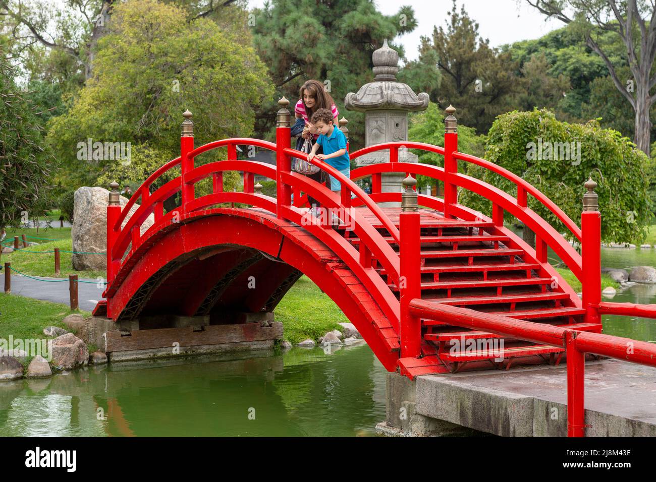 mother and son leaning out on japanese bridge Stock Photo - Alamy
