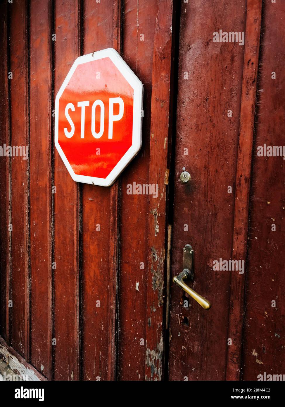 Stop sign on old worn wooden gate door Stock Photo - Alamy