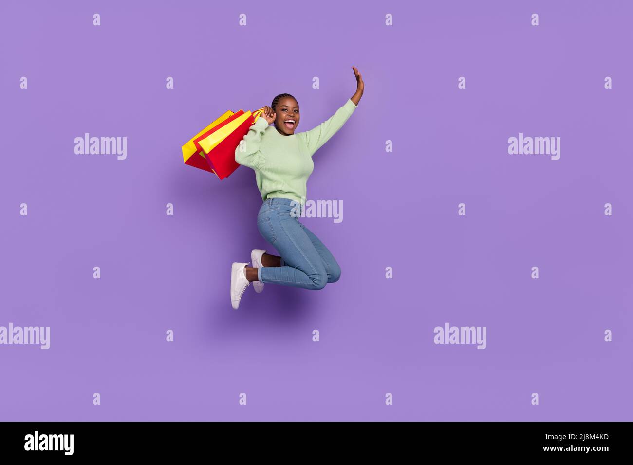 Full body image of good mood laughing woman excited after shopping buy ...