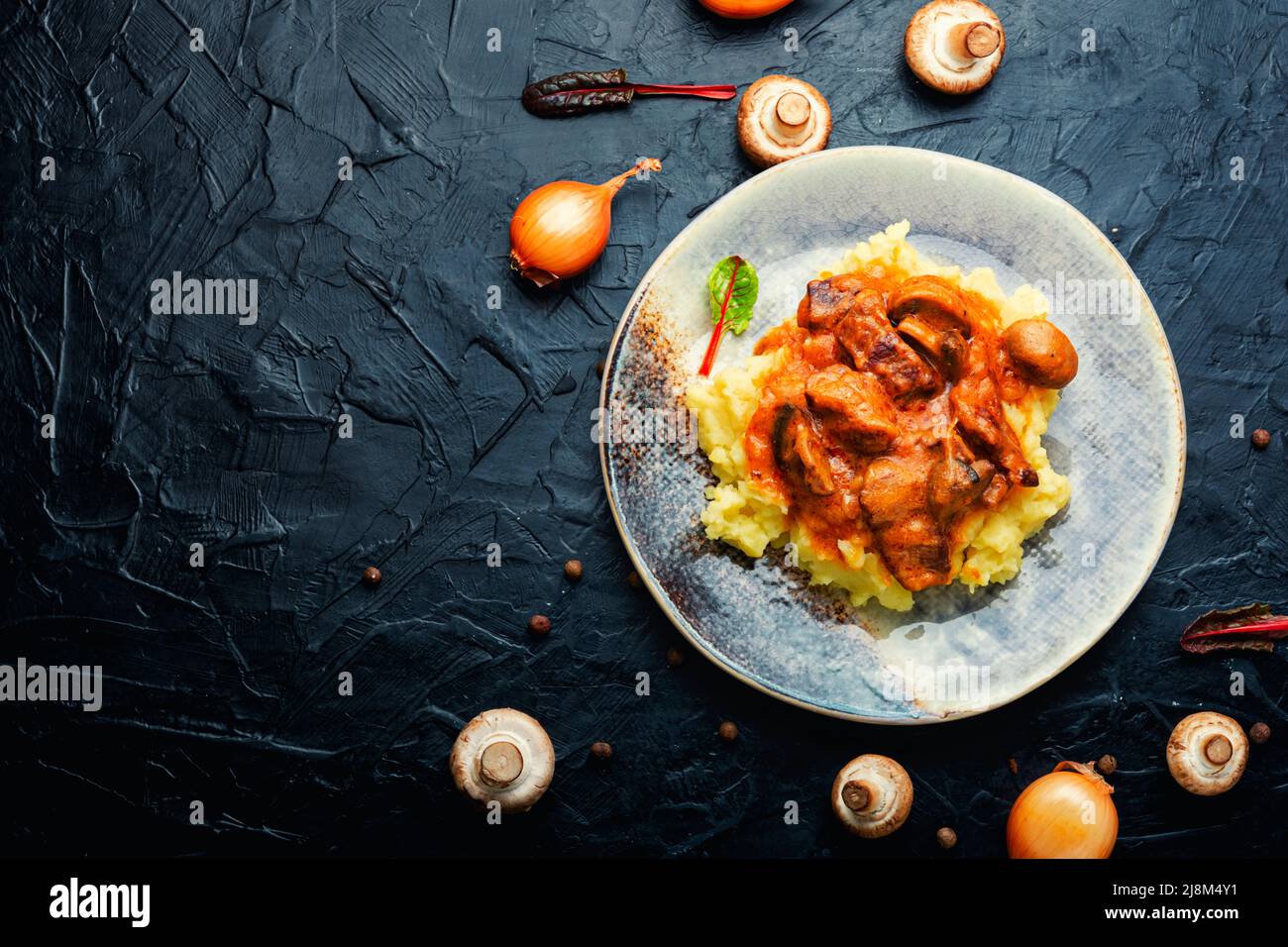 Fried meat with mushrooms, beef stroganoff from pork. Space for text ...