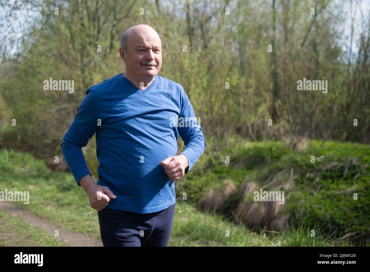 Active senior man is jogging. Healthy retirement lifestyle Stock Photo ...