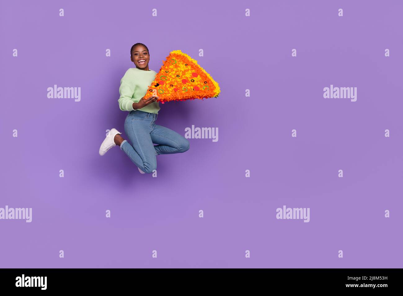 Full body image of overjoyed laughing lady eating huge slice of yummy ...