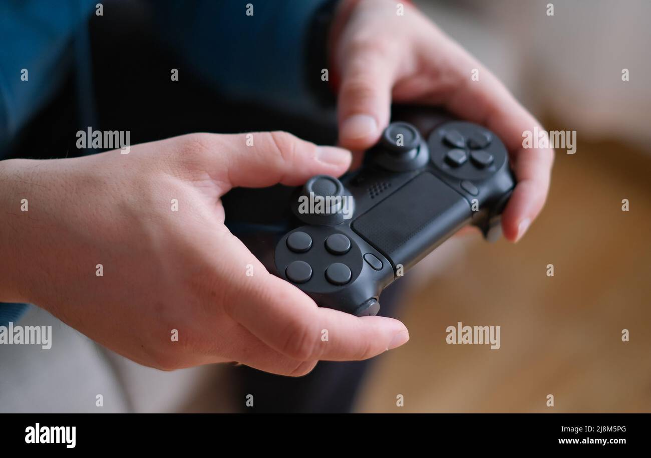 Joystick for game console in the mans hands.The concept of leisure and ...
