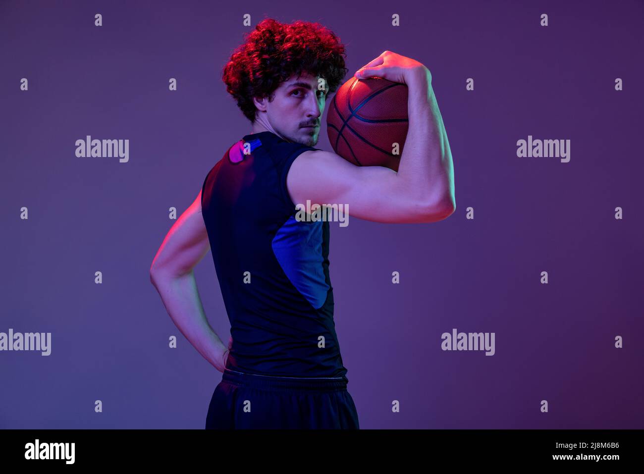Back view of male muscular basketball player wearing blue sportswear ...