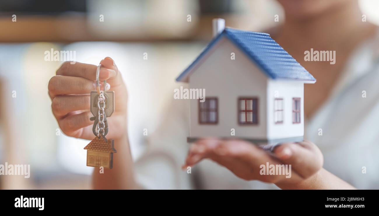 Close up Business woman or Real Estate agent giving house key after ...