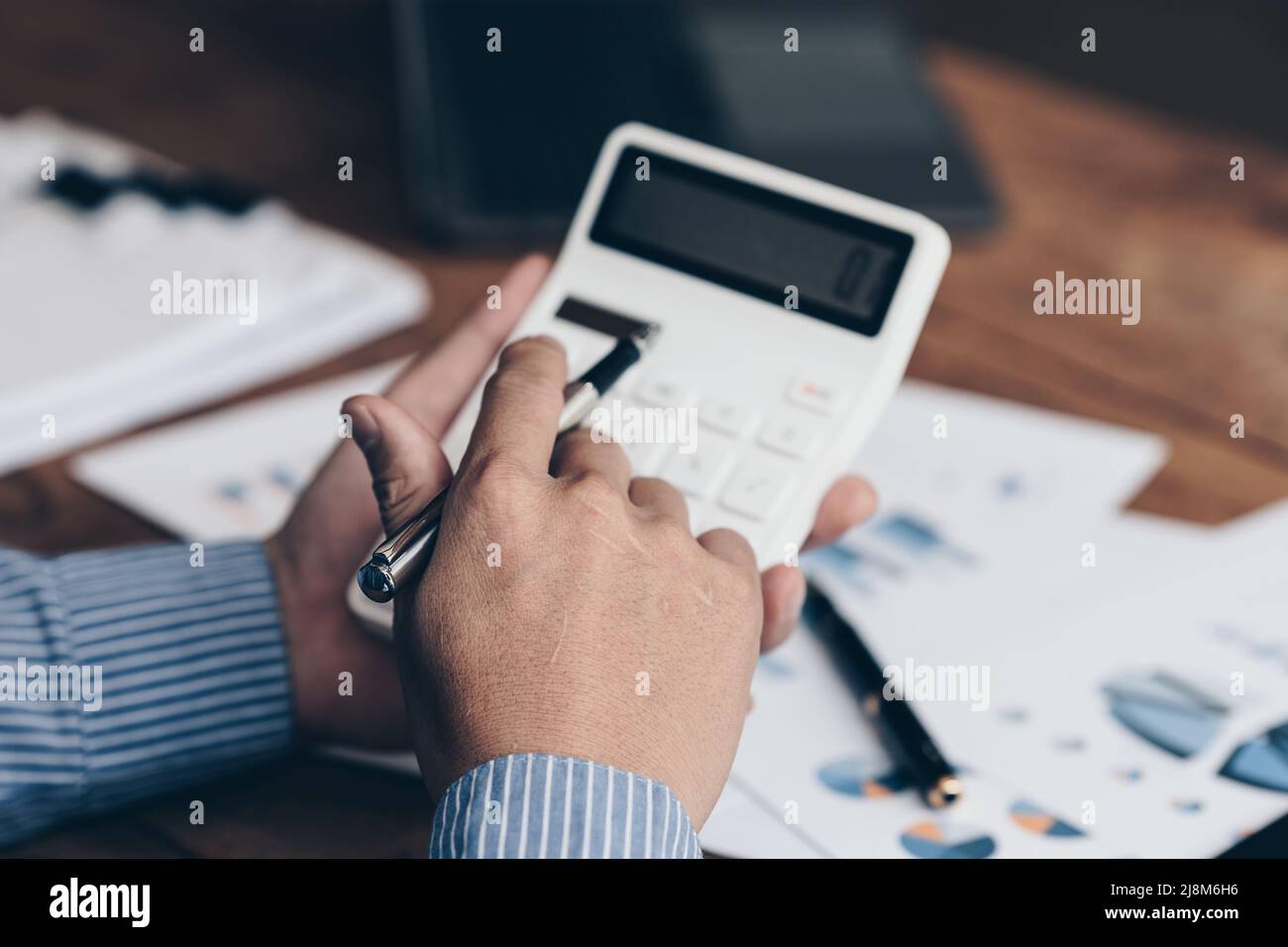 Close up Businessman hand using calculator to calculate the company's ...