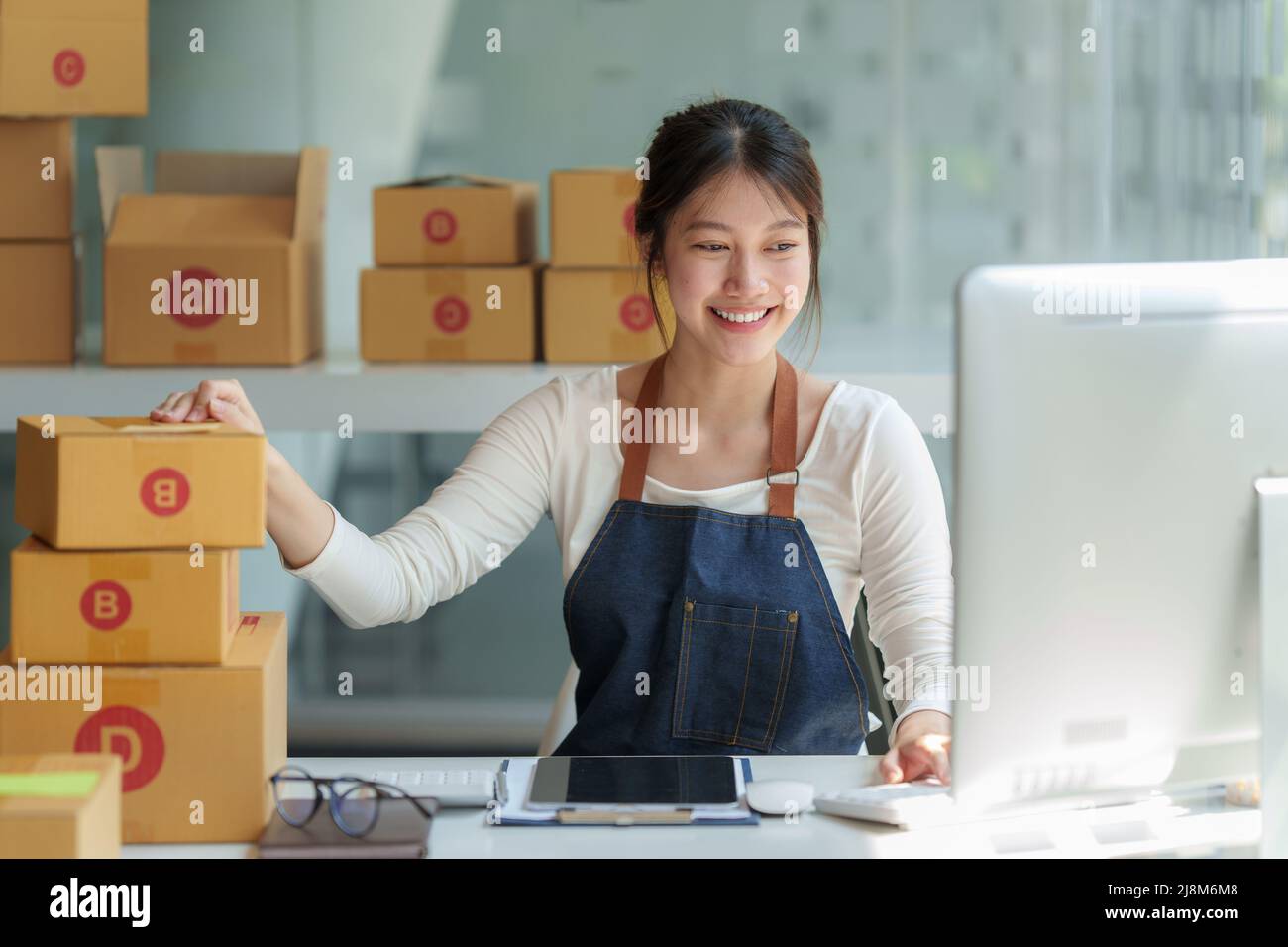 A portrait of Asian woman, e-commerce employee freelance with parcel ...