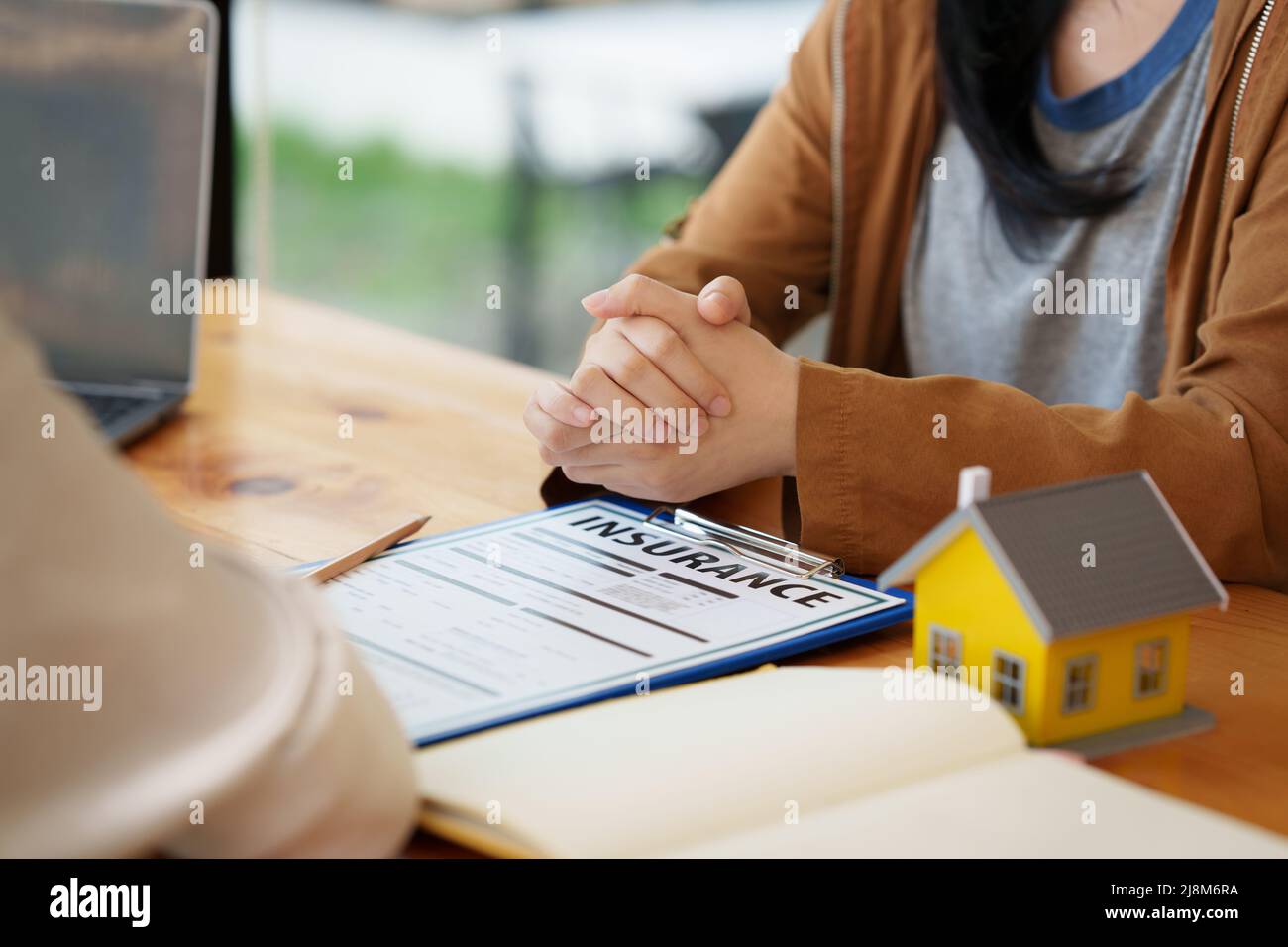 Real Estate Agent explain insurance and agreement contract to client ...