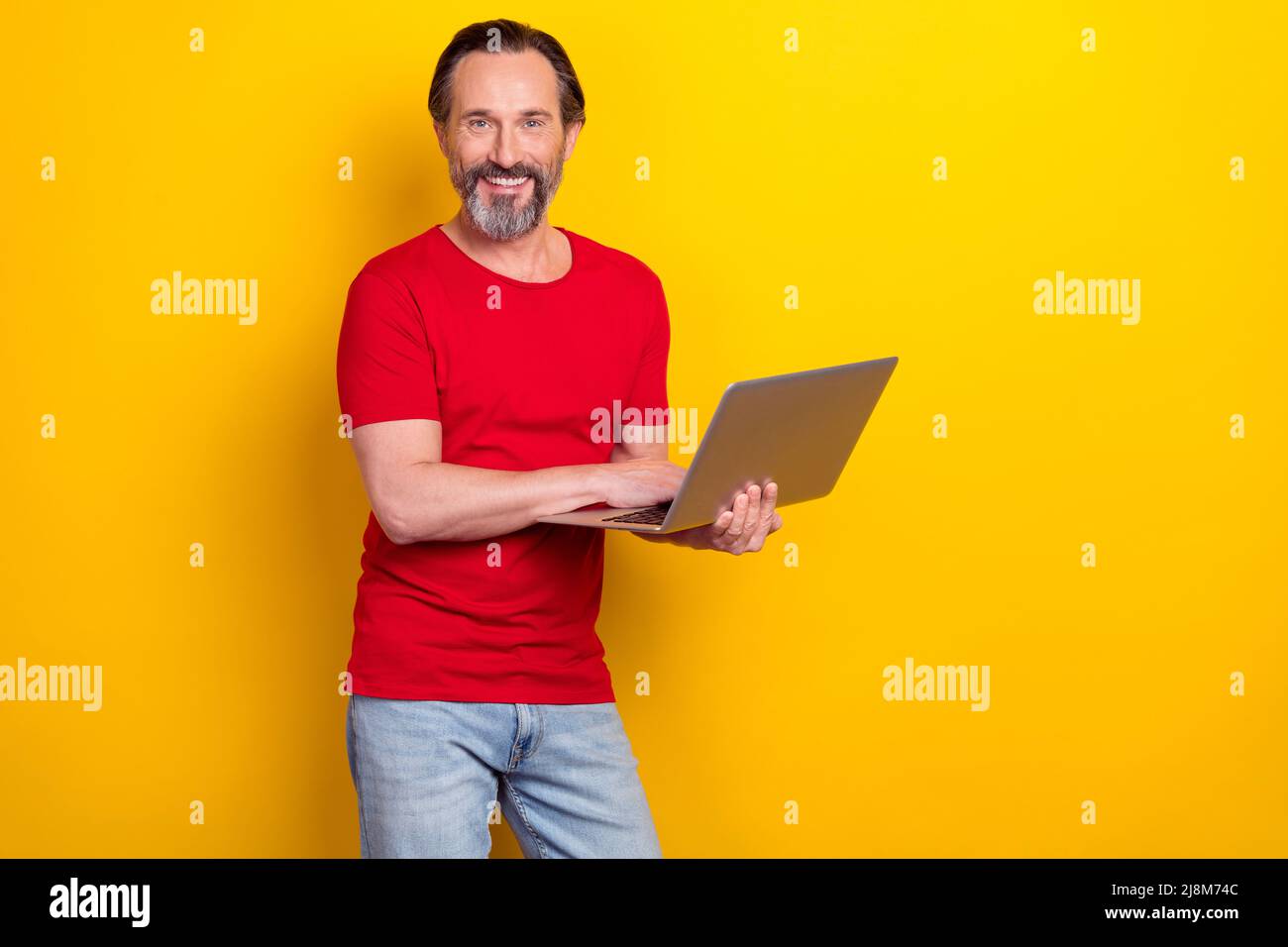 Photo of pretty charming retired man wear red t-shirt typing modern ...