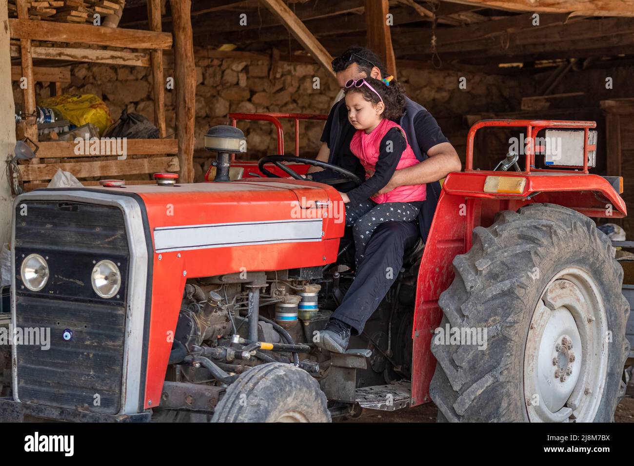 Image of father teaching his daughter tractor with his daughter Stock ...