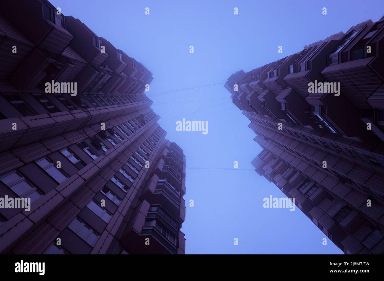 Two tall residential buildings in the form of a tower, immersed in a ...