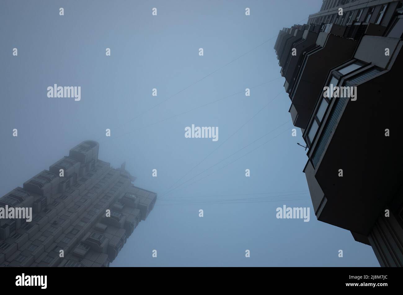 Two tall residential buildings in the form of a tower, immersed in a ...