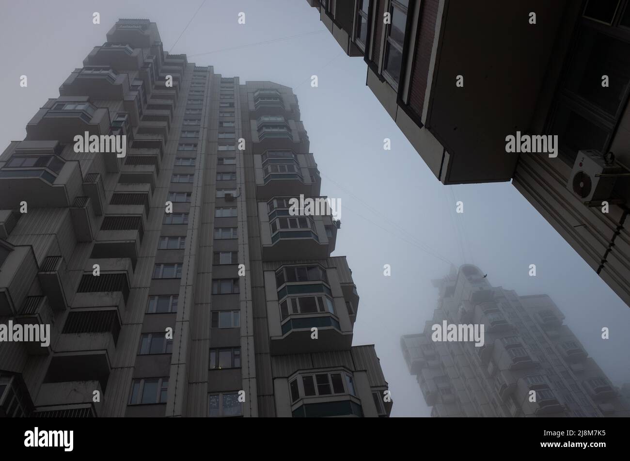 Two tall residential buildings in the form of a tower, immersed in a ...