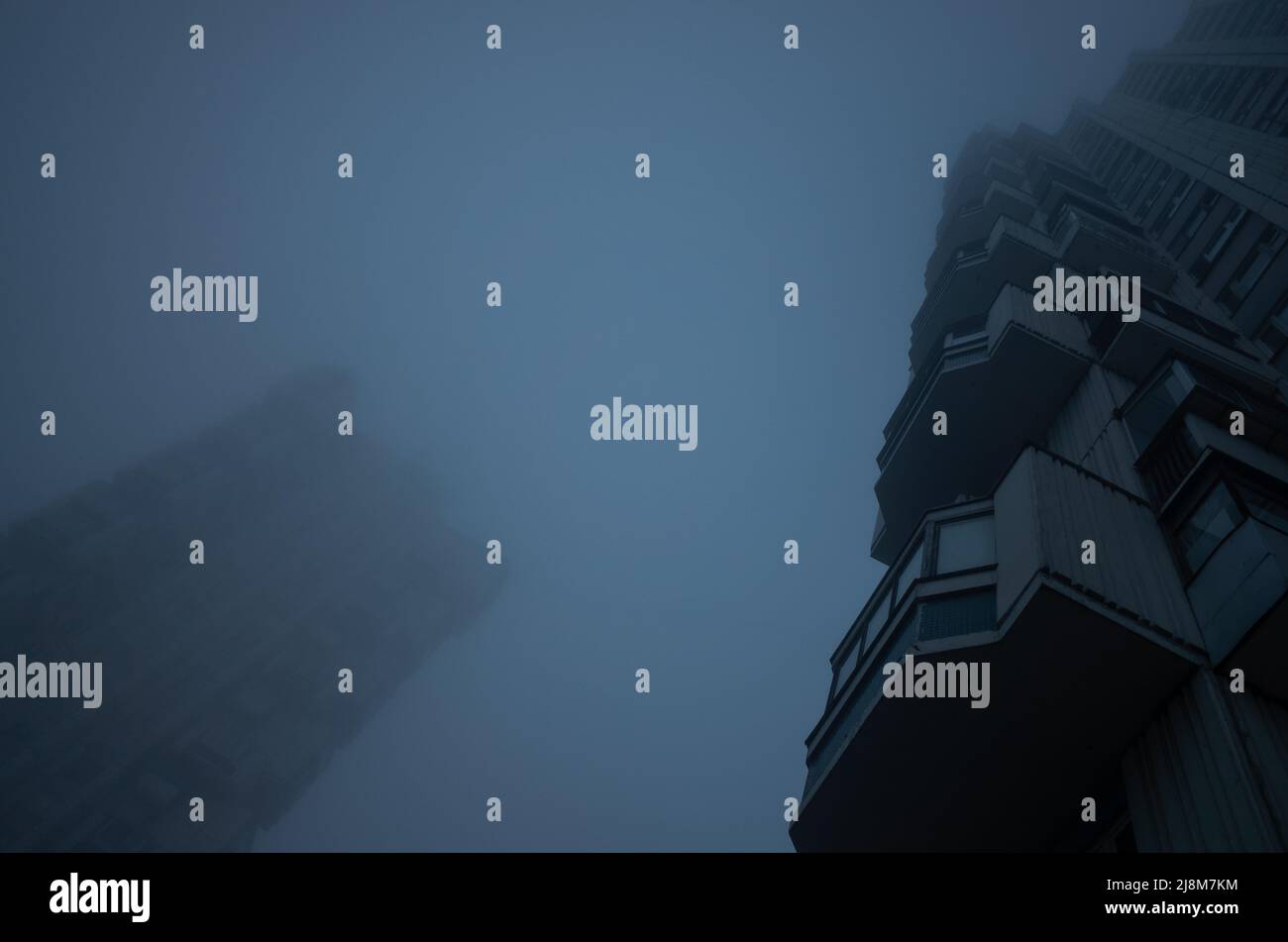 Two tall residential buildings in the form of a tower, immersed in a ...