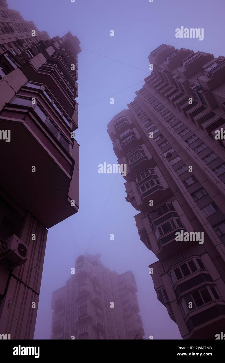 Three tall residential buildings in the form of a tower, immersed in a ...