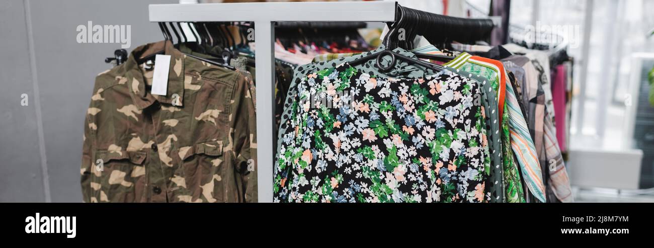 Vintage clothes on hangers in second hand, banner Stock Photo - Alamy