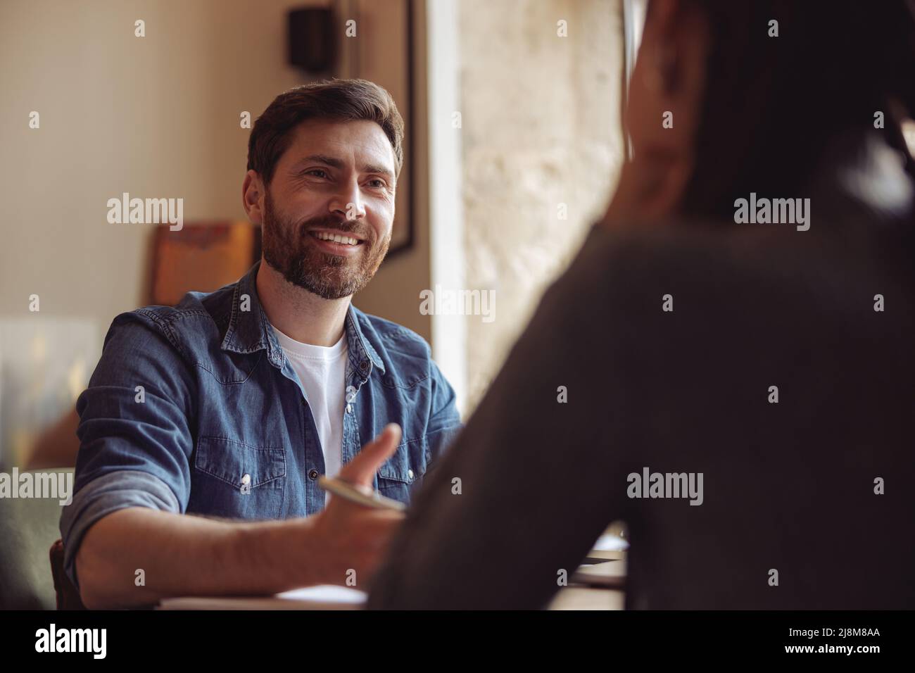 Caucasian handsome man at business meeting in cafe. Successful male ...