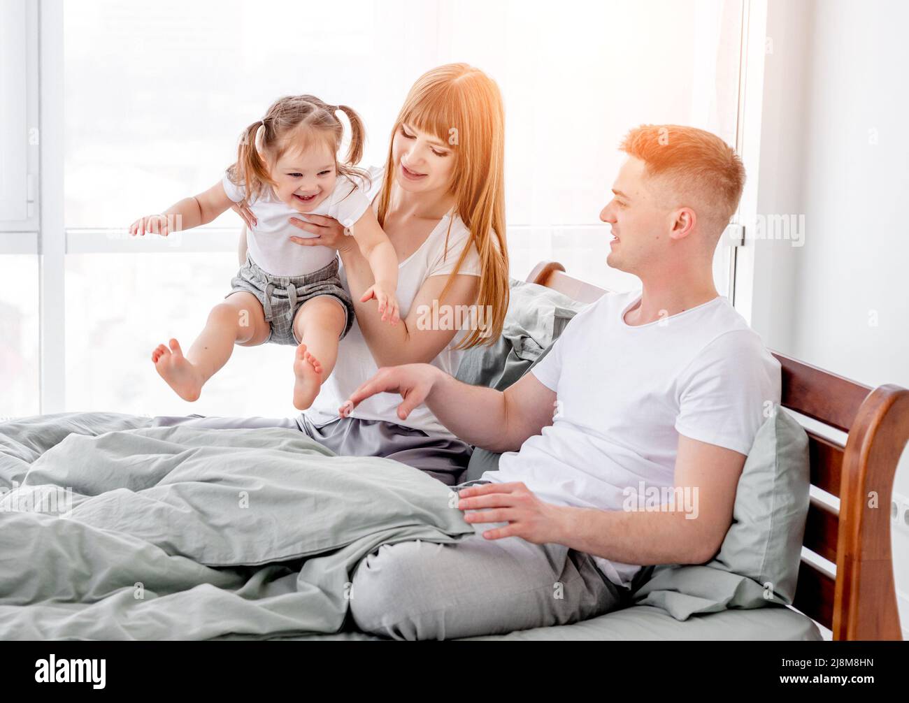Sunny family morning in the bed Stock Photo - Alamy