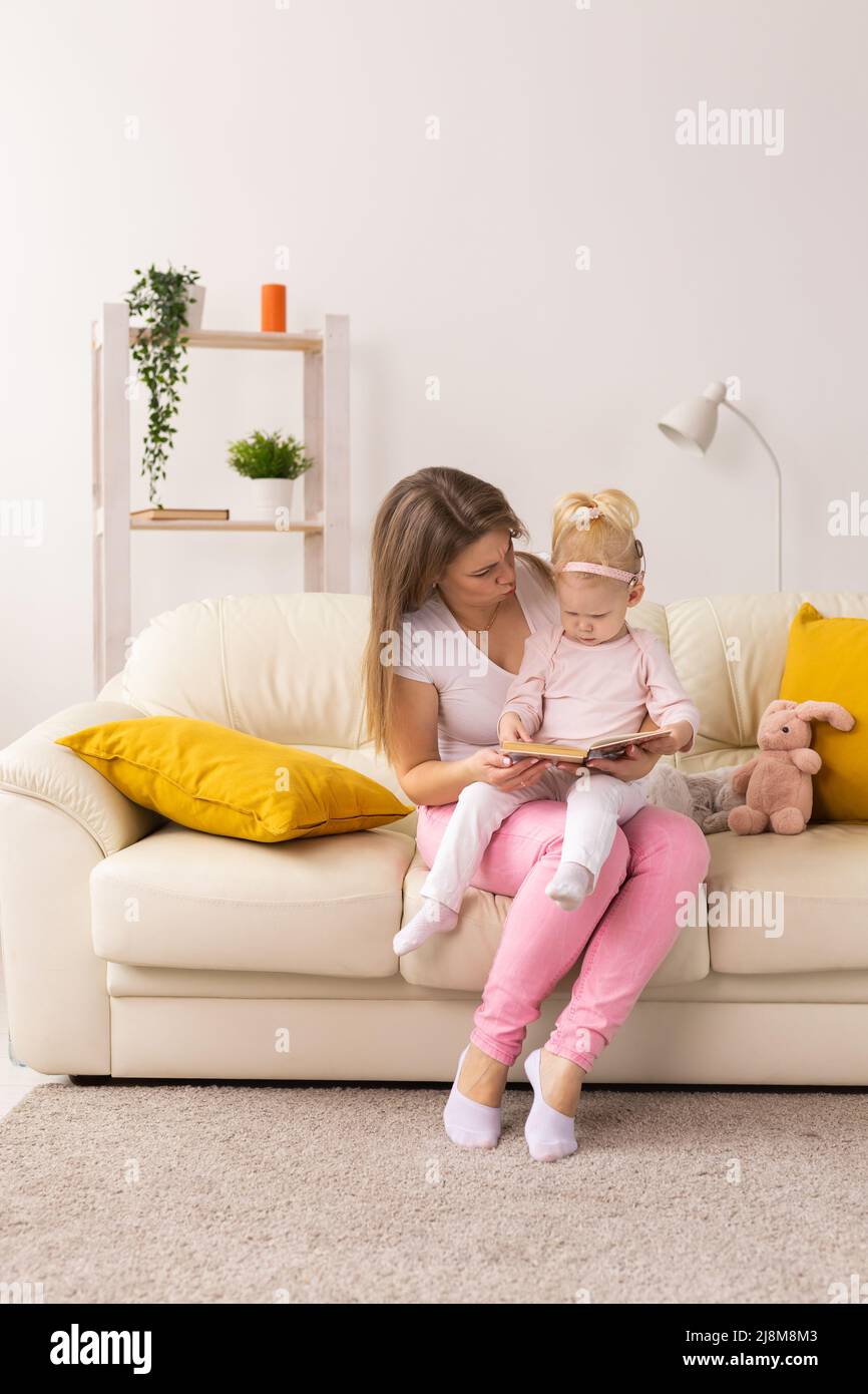 Happy child girl with cochlear implant having fun with her mother ...