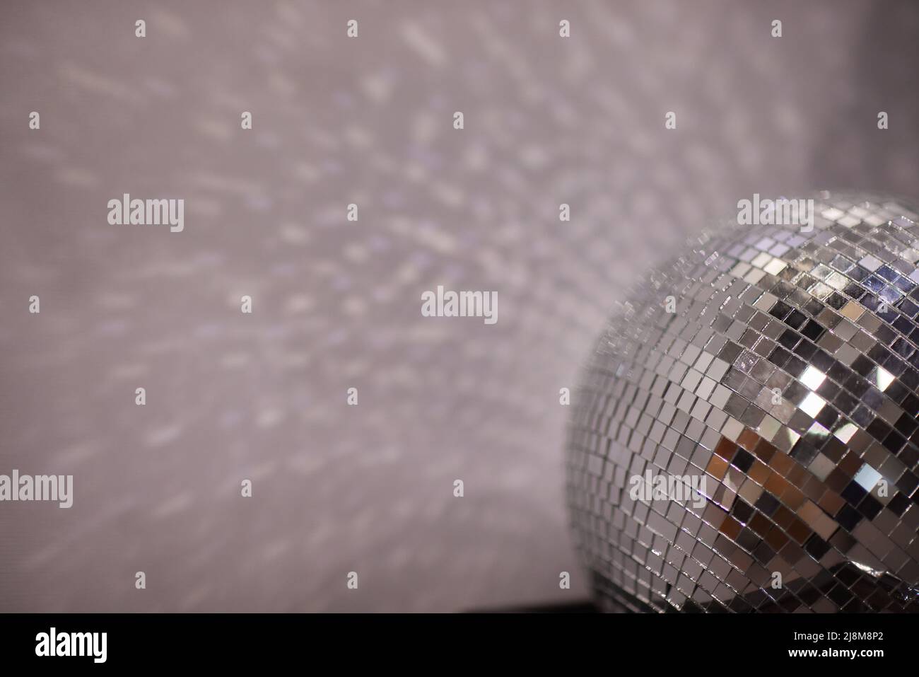 Shining disco ball on grey background close-up Stock Photo - Alamy