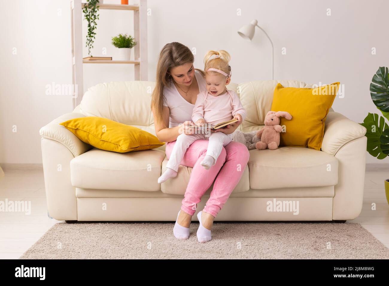 Happy child girl with cochlear implant having fun with her mother ...