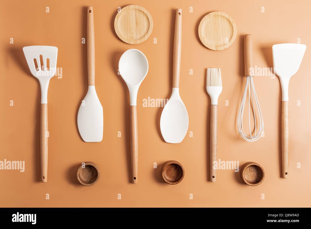 kitchen background. Silicone white cooking tools with wooden handle on ...