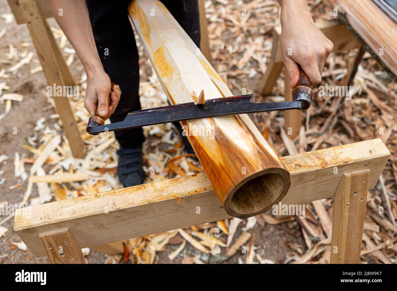 Woodworking, making a new didgeridoo from alder tree Stock Photo - Alamy